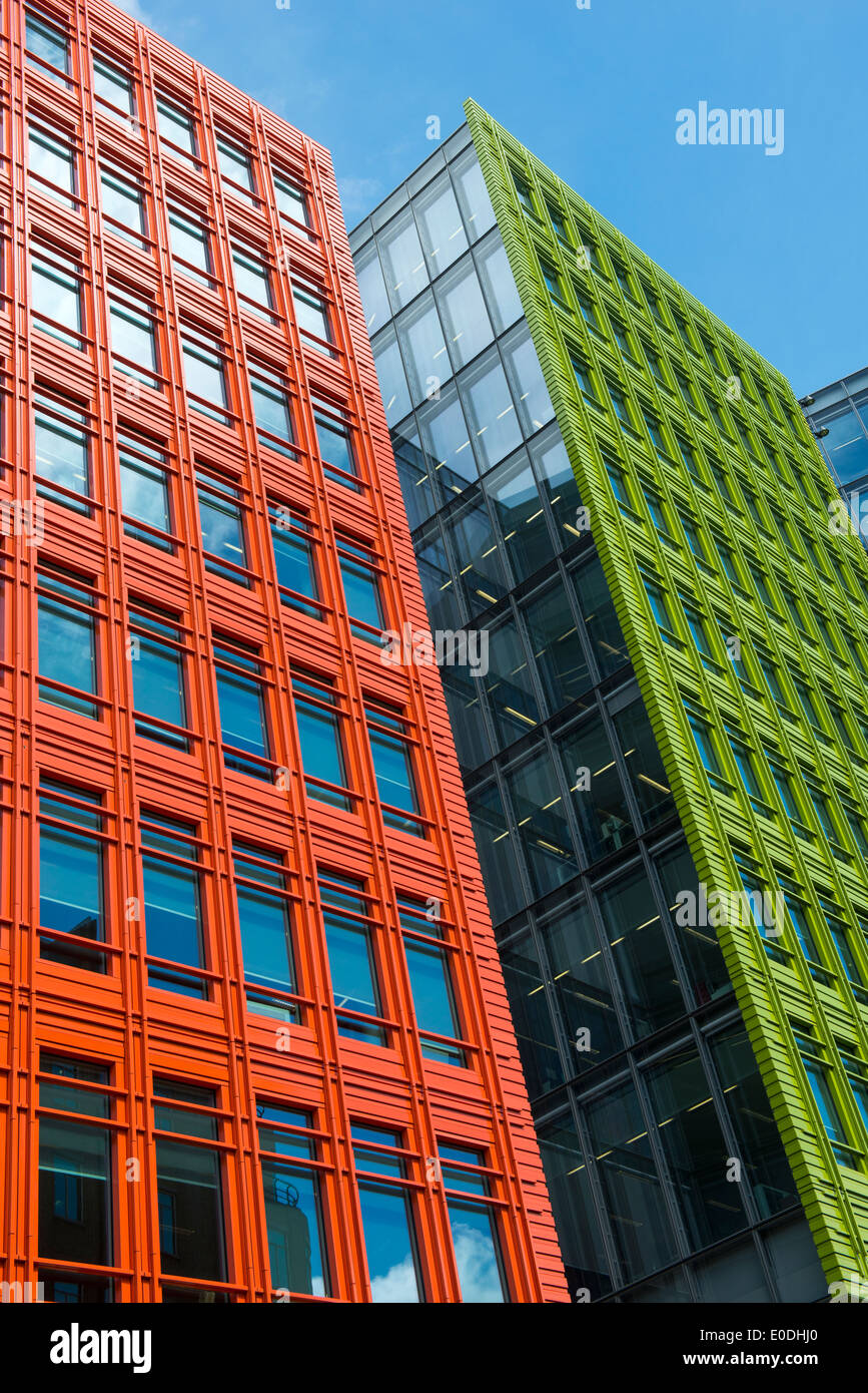 A bright orange and green facade on an office building at Central Saint ...