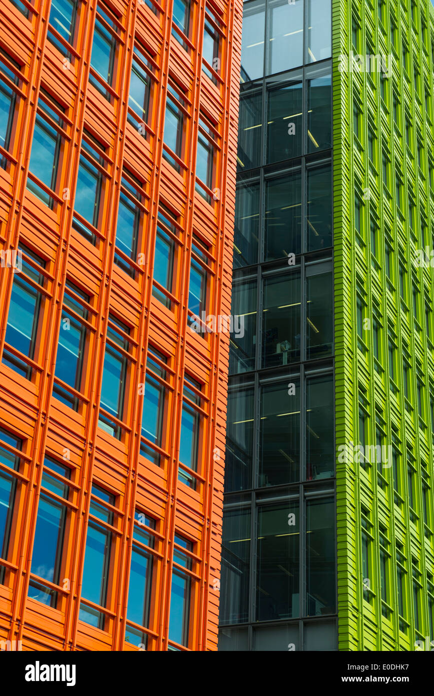 A bright orange and green facade on an office building at Central Saint ...