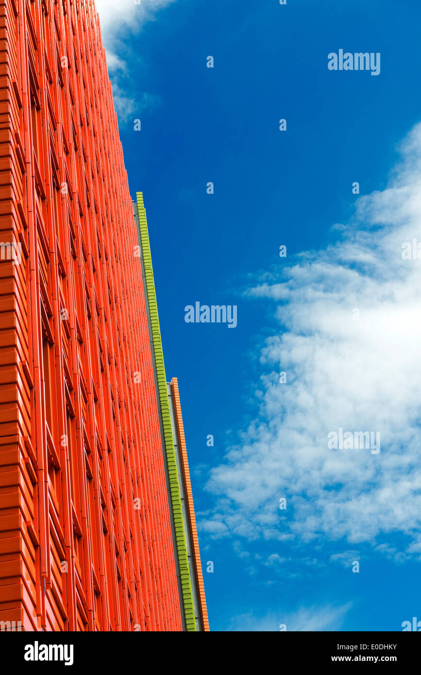 A bright orange and green facade on an office building at Central Saint ...
