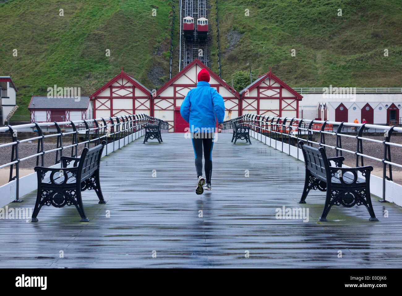 Mature man jogging on Saltburn pier in the rain. Saltburn by the sea ...