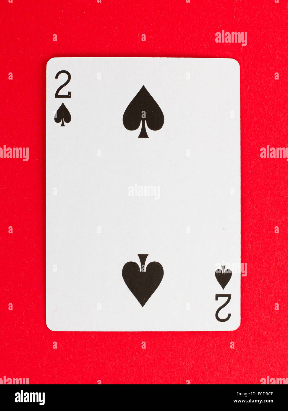 Playing card (two) isolated on a red background Stock Photo - Alamy