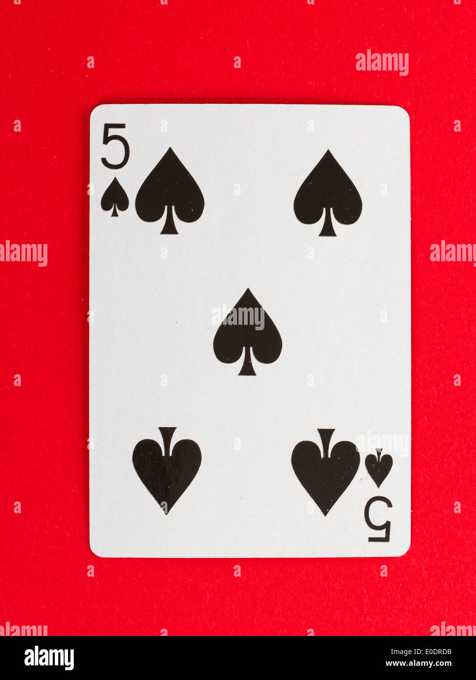 Old playing card (five) isolated on a red background Stock Photo - Alamy