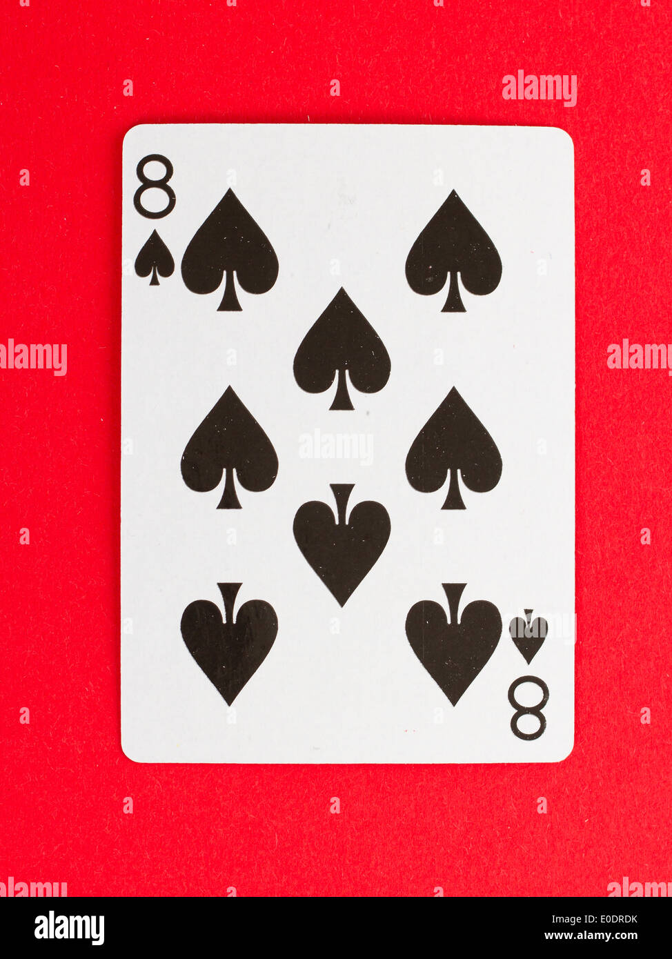 Old playing card (eight) isolated on a red background Stock Photo - Alamy