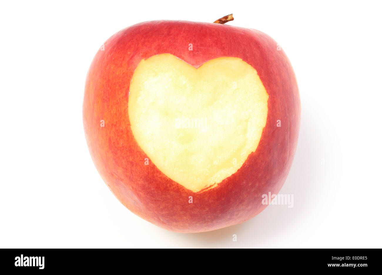 Closeup of heart carved on red apple. Isolated on white background ...