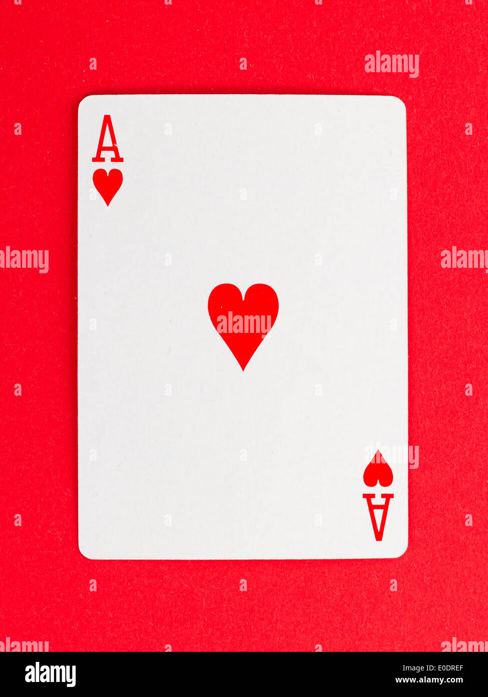 Old playing card (ace) isolated on a red background Stock Photo - Alamy