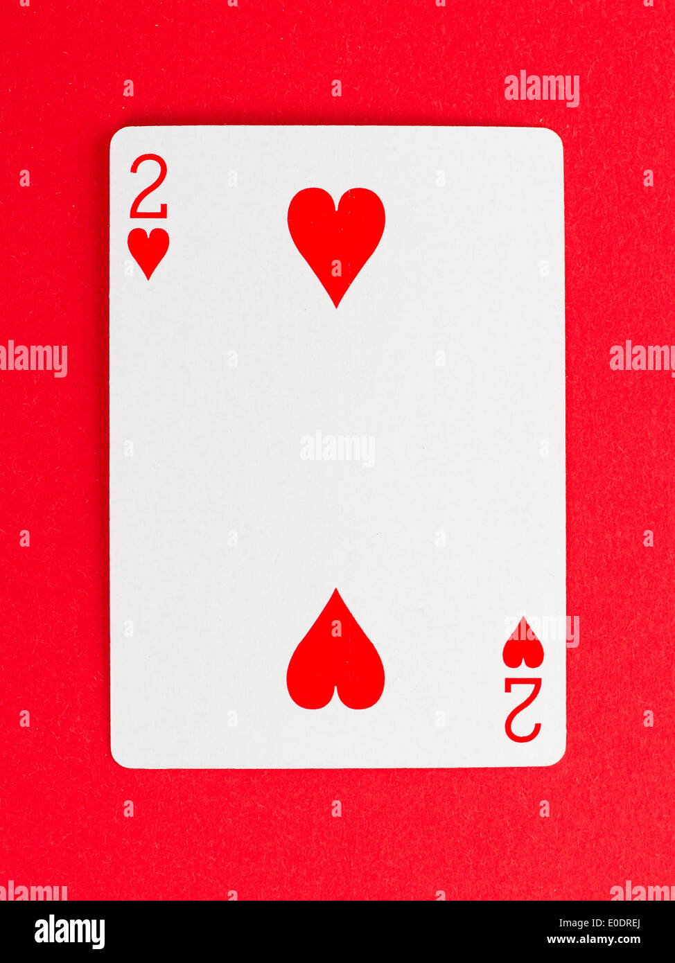 Old playing card (two) isolated on a red background Stock Photo - Alamy