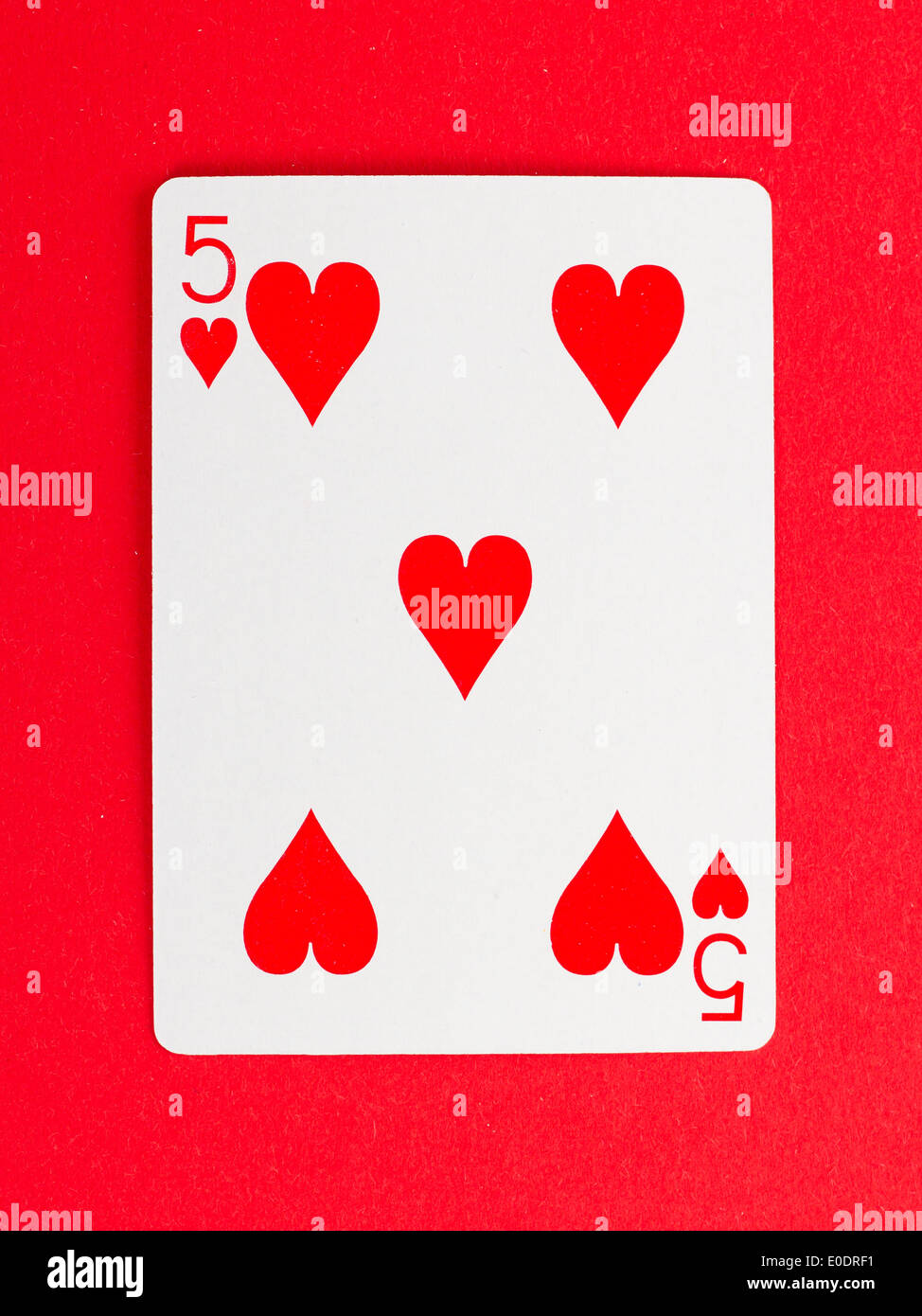 Old playing card (five) isolated on a red background Stock Photo - Alamy
