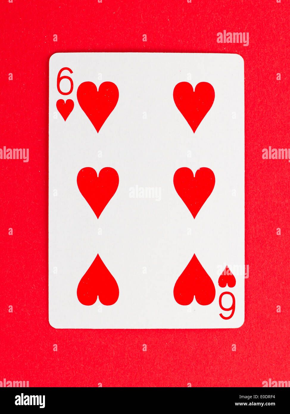 Old playing card (six) isolated on a red background Stock Photo - Alamy