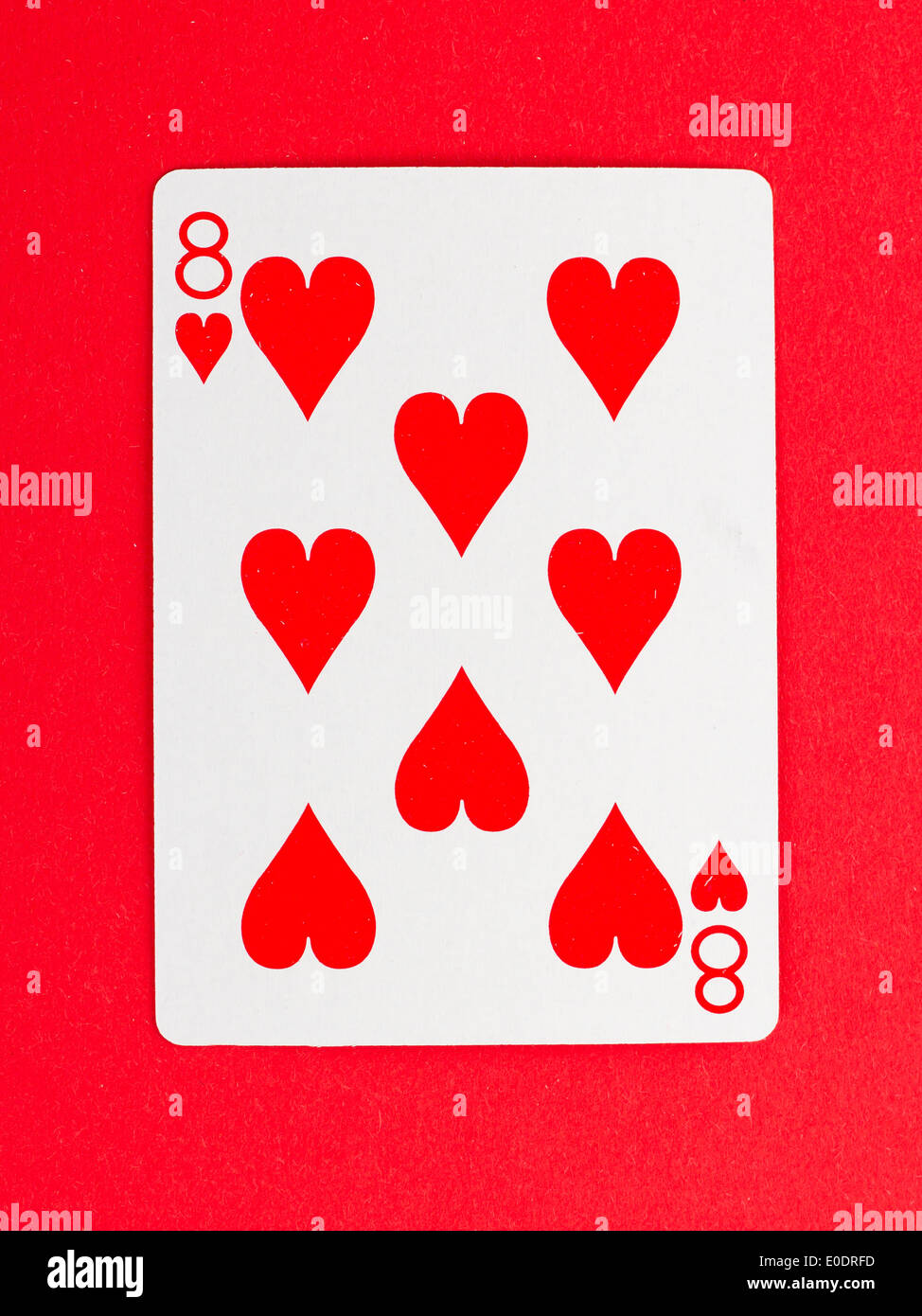 Old playing card (eight) isolated on a red background Stock Photo - Alamy