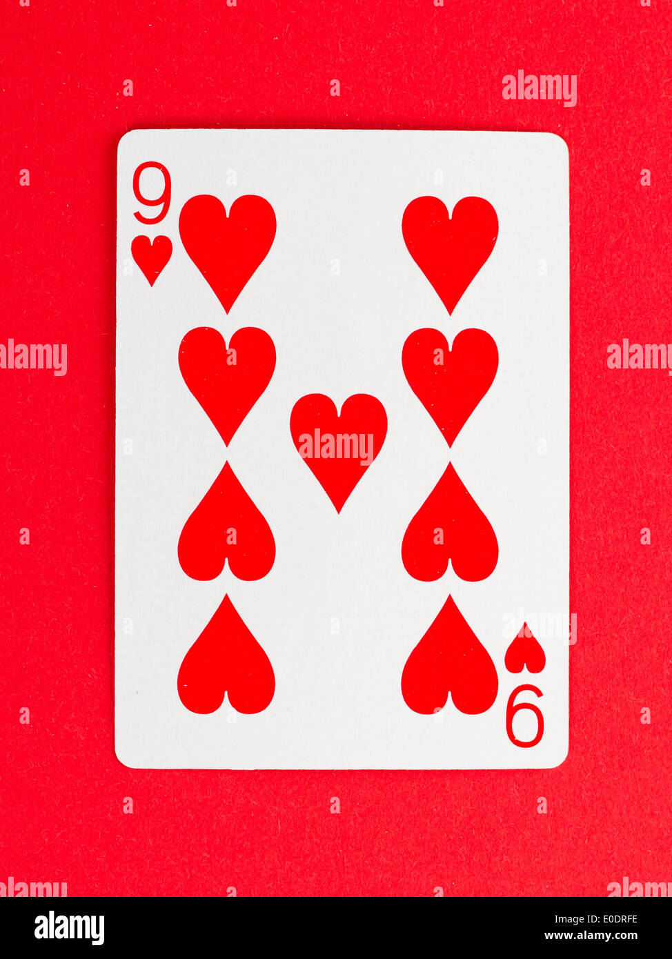 Old playing card (nine) isolated on a red background Stock Photo - Alamy