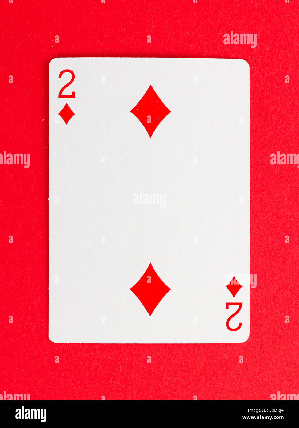 Playing card (two) isolated on a red background Stock Photo - Alamy