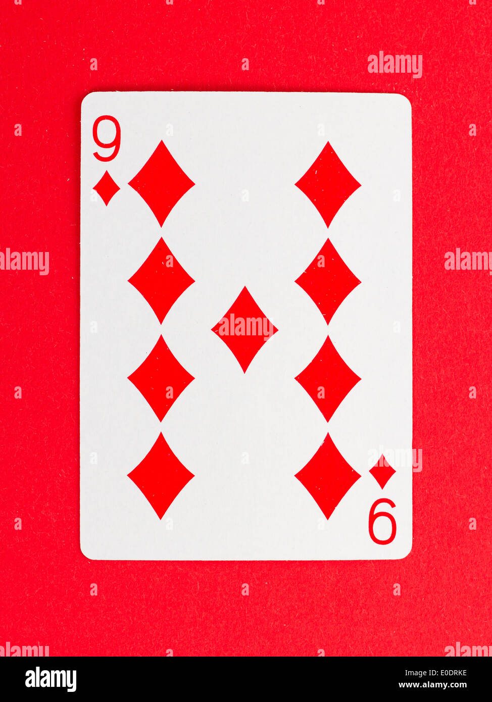 Old playing card (nine) isolated on a red background Stock Photo - Alamy