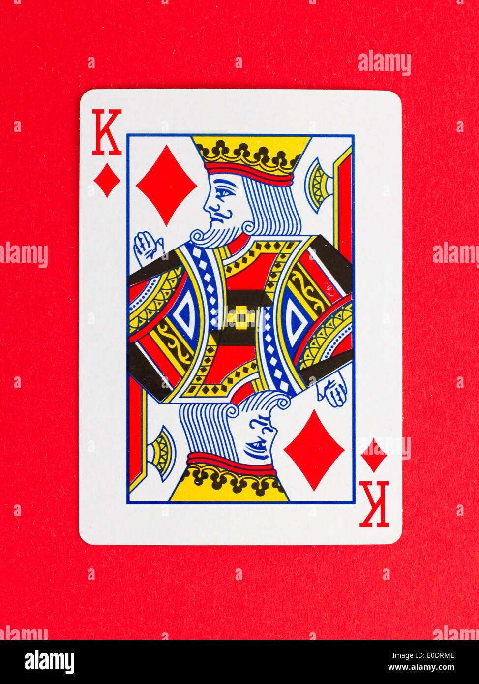 Playing card (king) isolated on a red background Stock Photo - Alamy