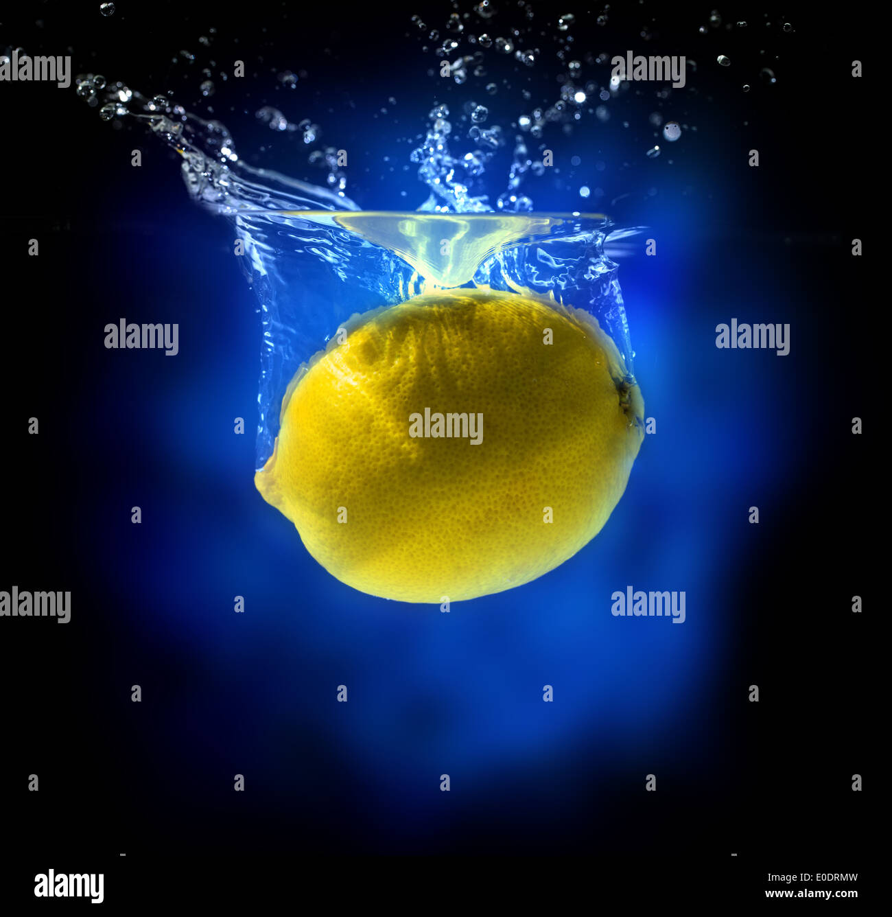 Yellow lemon in water splash Stock Photo - Alamy