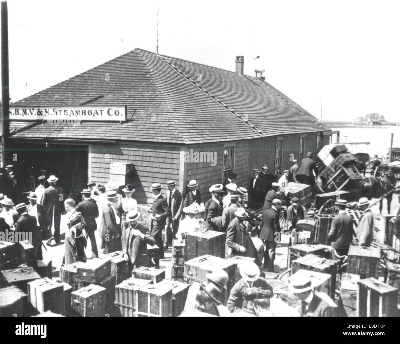 This image shows tourists with baggage around the early 1900s ...