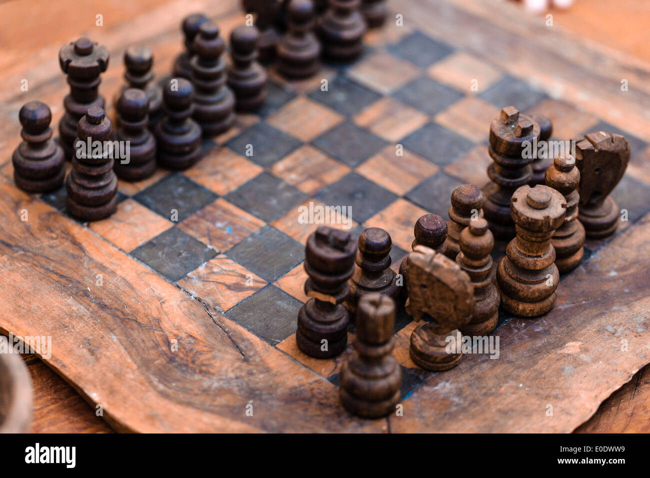 a very old and weathered chess board with chess pieces Stock Photo - Alamy