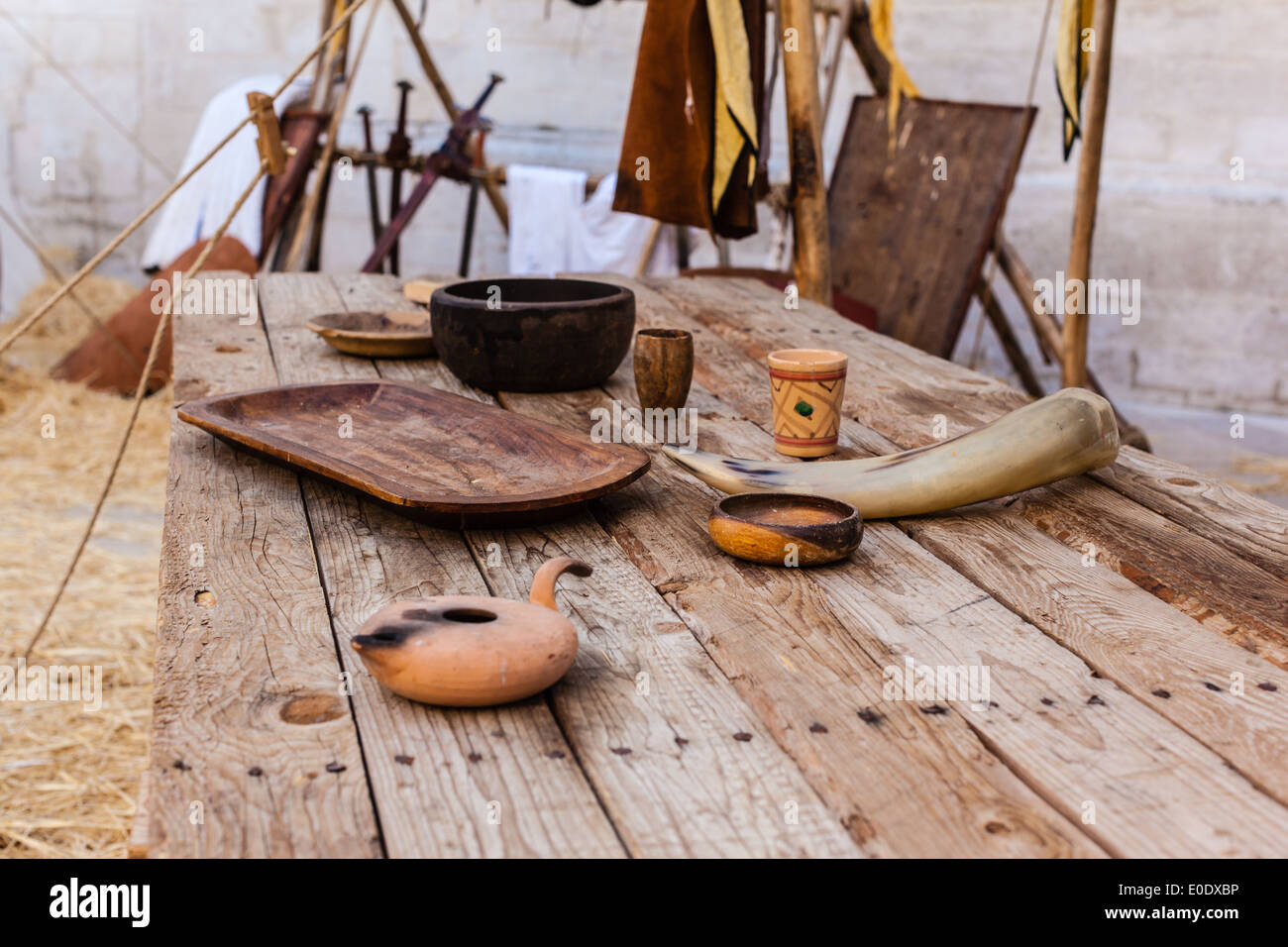 a big and old wooden table with some medieval items on it Stock Photo ...