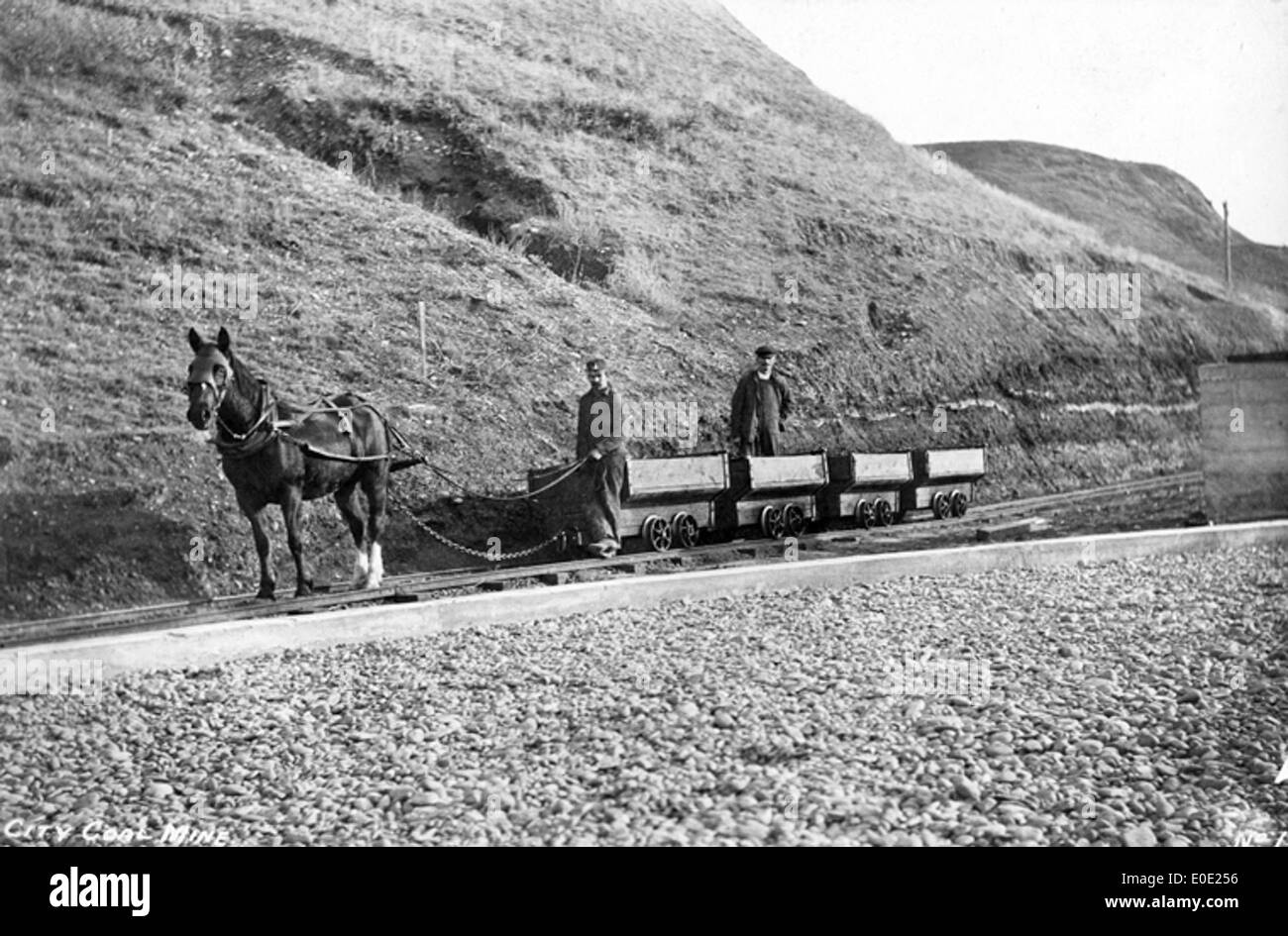 A photograph depicting horse-drawn coal cars outside the City Mine in ...