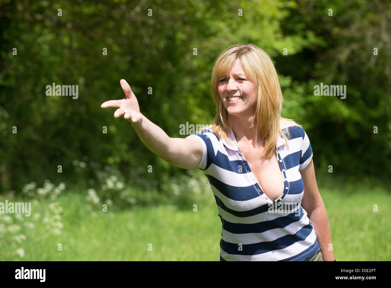 Woman with open hand and outstretched arm catching and throwing Stock ...