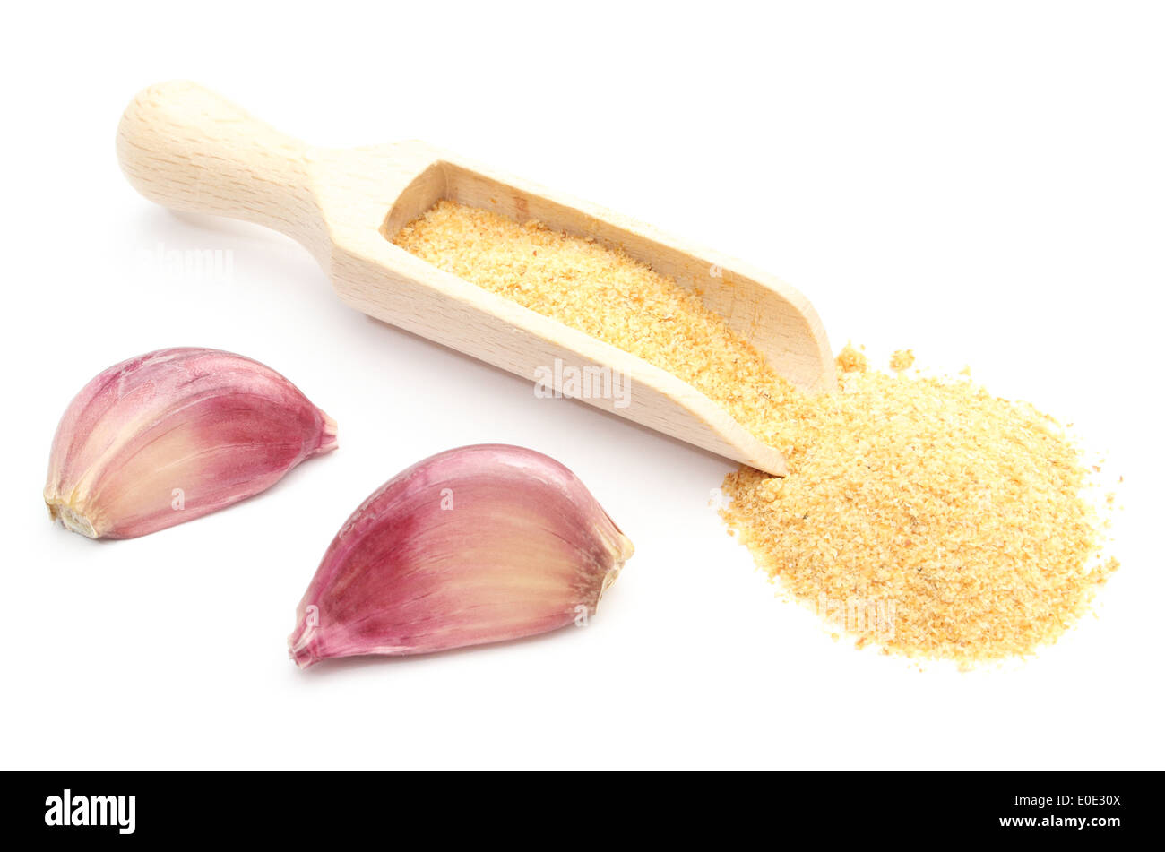 Two fresh clove garlic and heap of loose garlic on wooden spoon ...