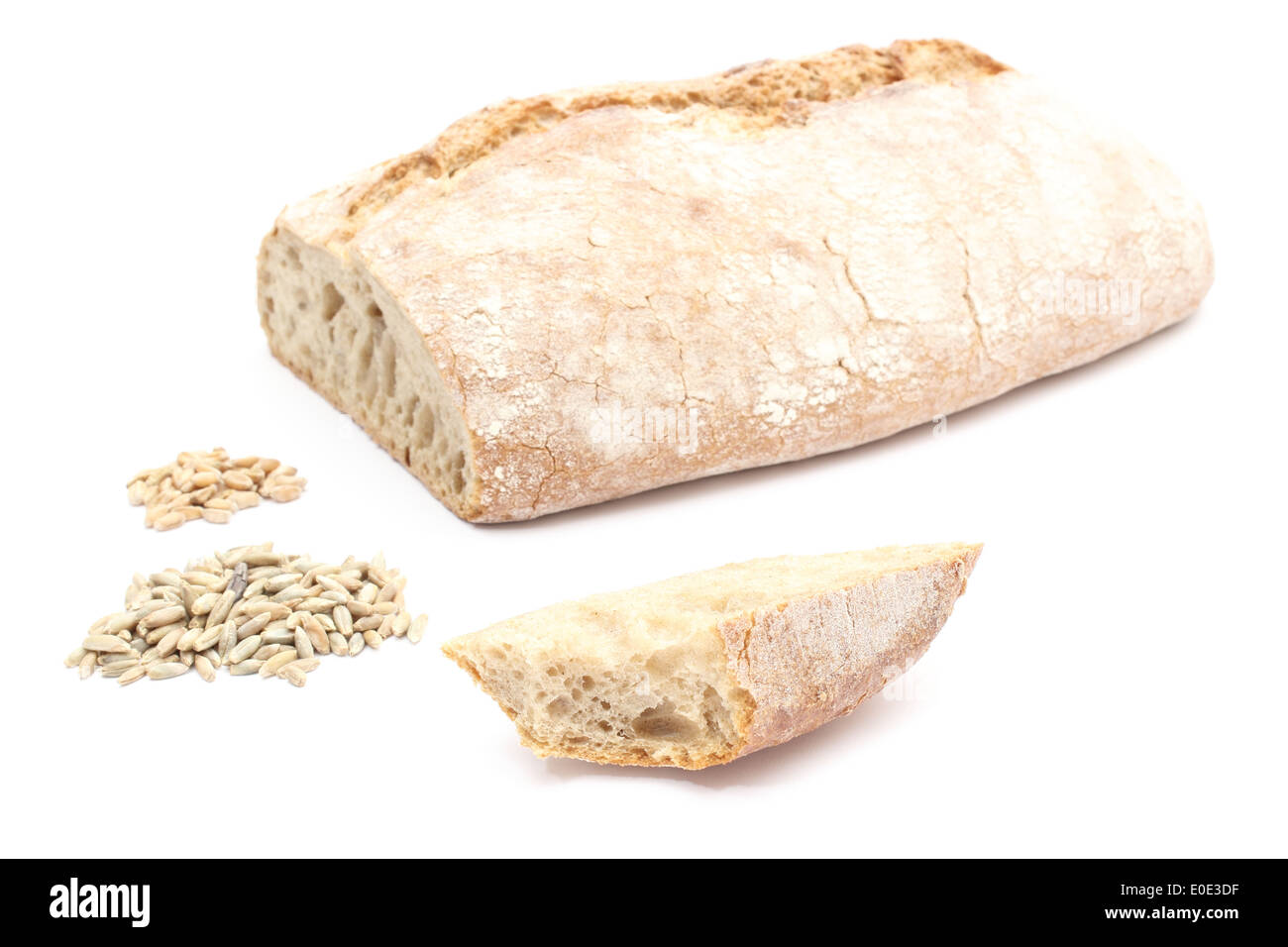 Closeup of slice of rye bread, loaf bread and heap of rye and wheat grain. Isolated on white ...