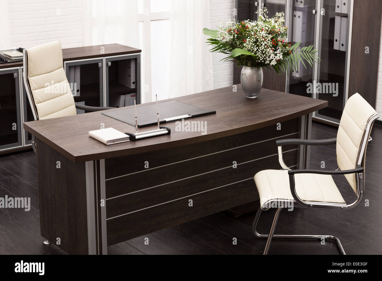 bouquet of flowers on a desk at modern office Stock Photo - Alamy