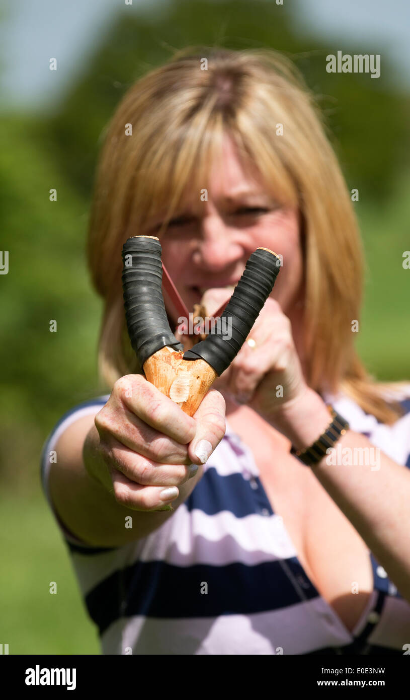 Woman firing a catapult in the countryside England UK Stock Photo - Alamy