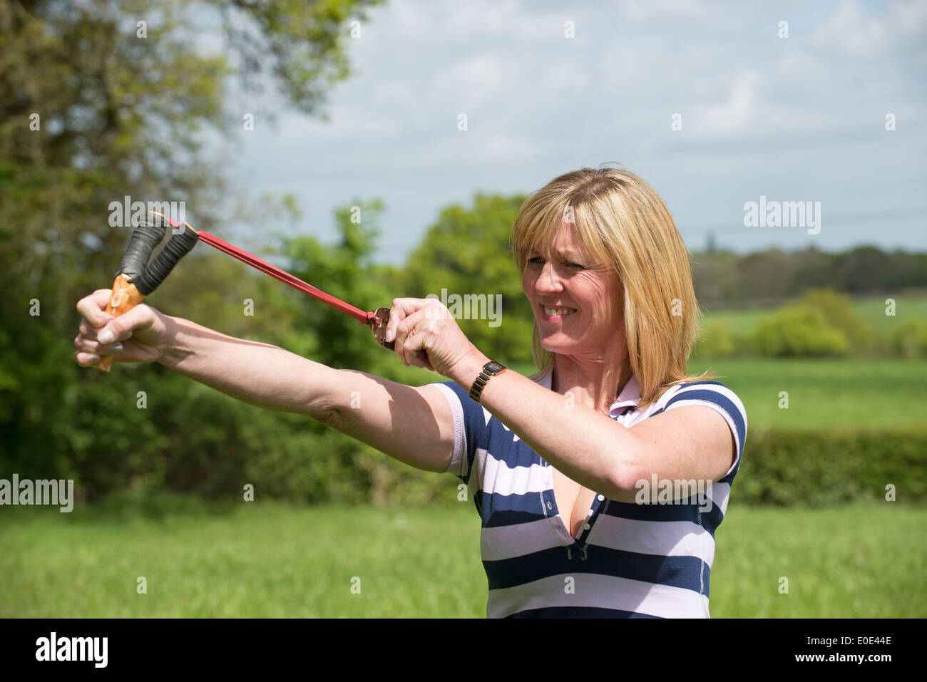Woman firing a catapult in the countryside England UK Stock Photo - Alamy