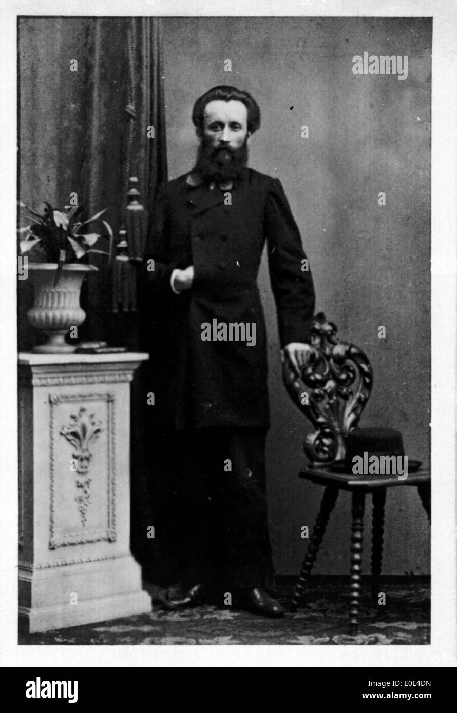 A portrait of a standing man, likely taken in the early 20th century ...