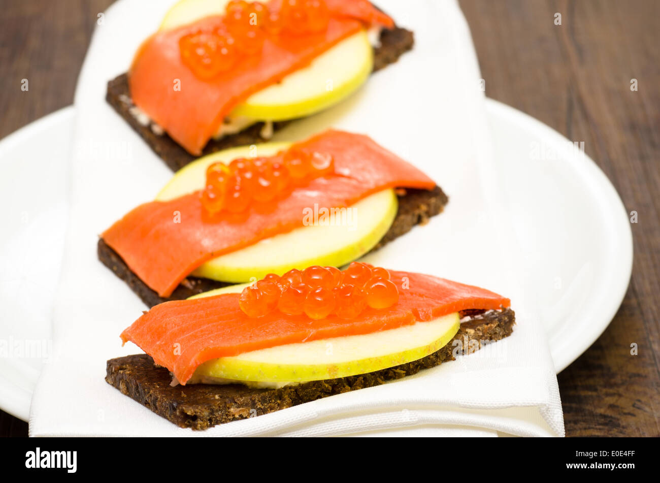 Canapes with wild salmon, caviar and apple slice Stock Photo - Alamy