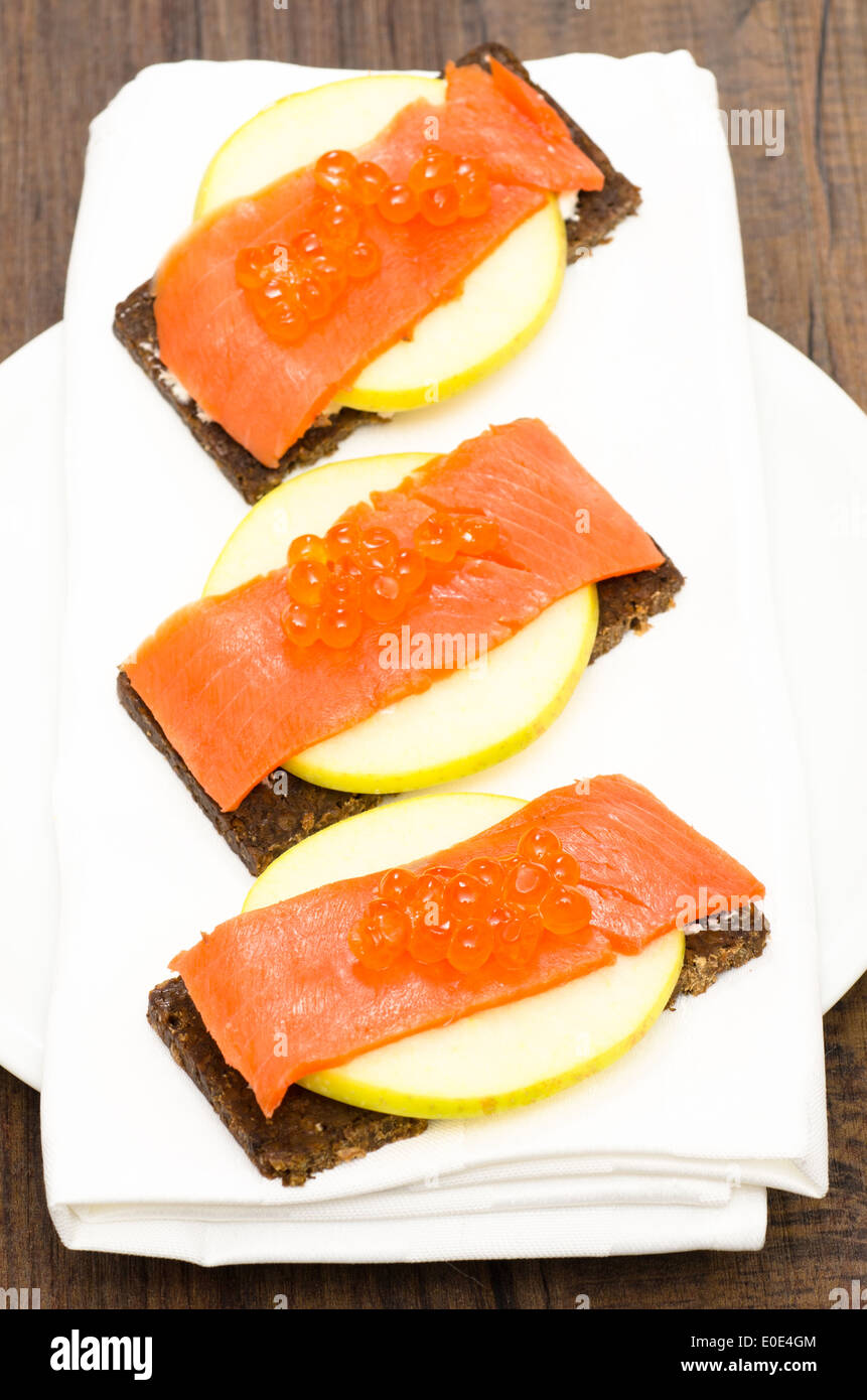 Canapes with salmon, caviar and apple on a pumpernickel bread Stock ...