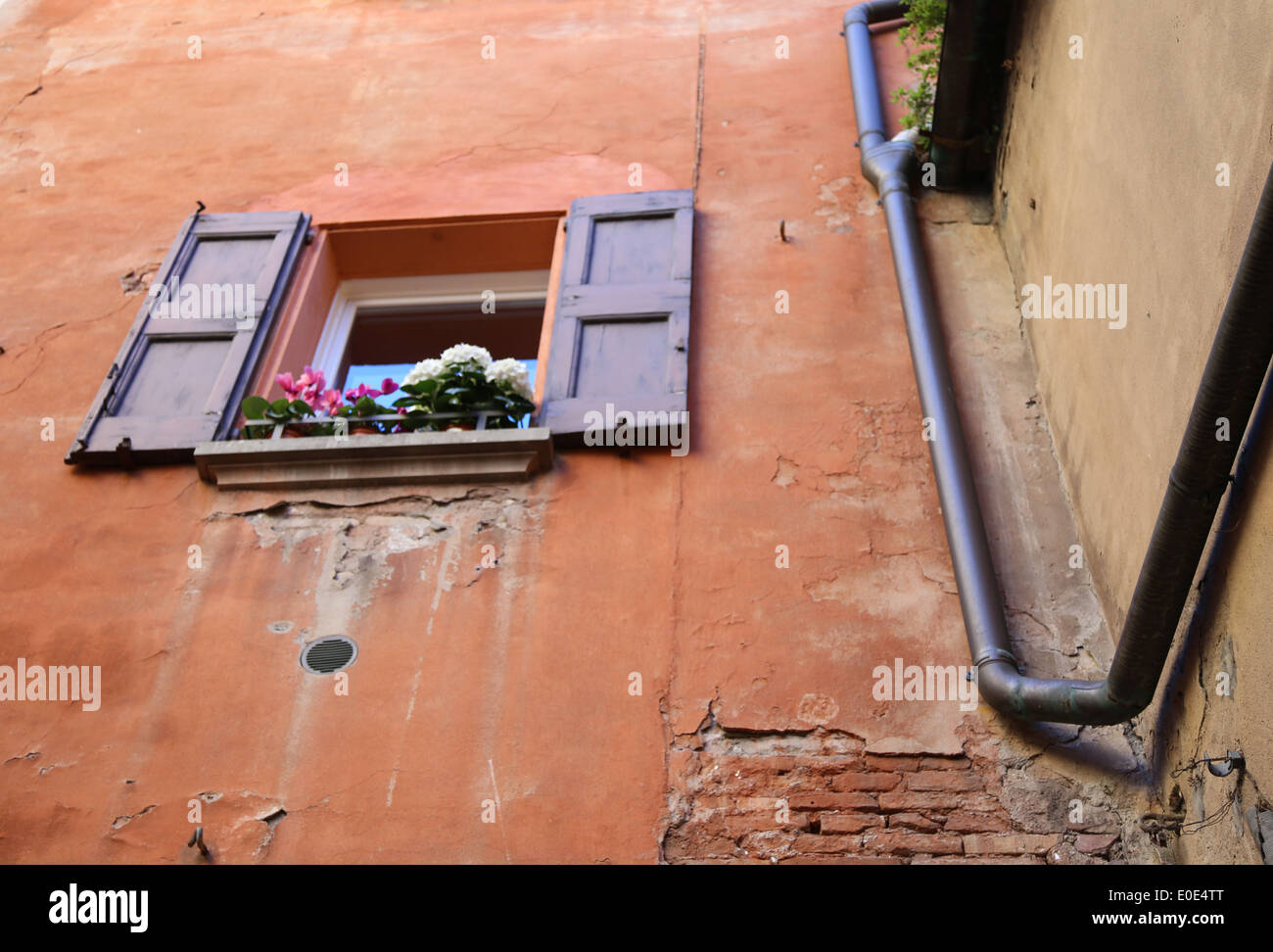 Window with open shutters and flowers - view from below Stock Photo - Alamy