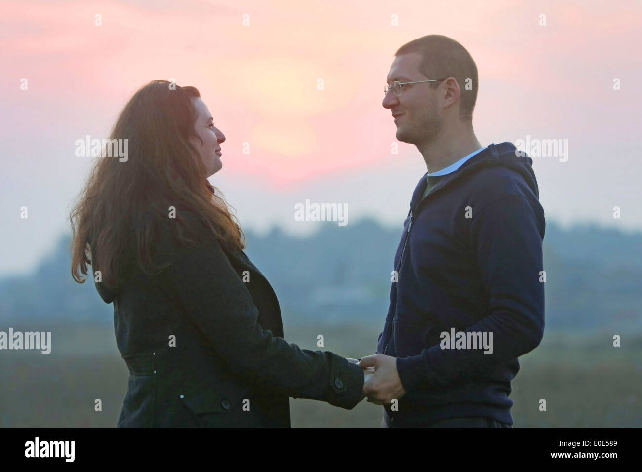 Profiles of romantic couple looking at each other with background of ...