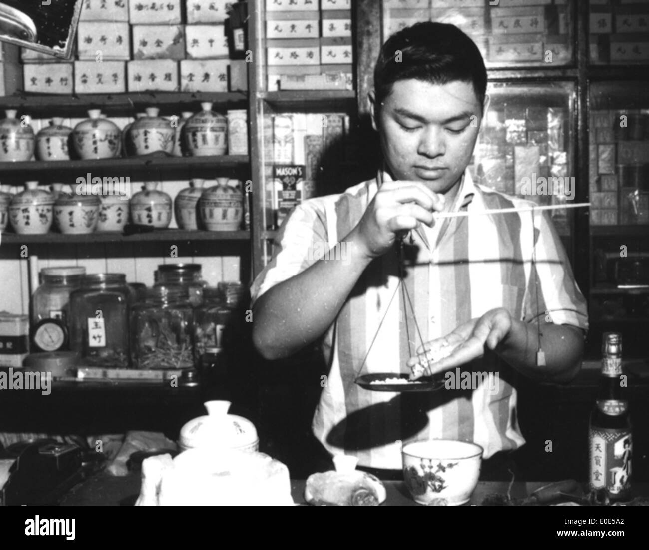 This image shows the proprietor of a Chinese store, likely taken in the ...