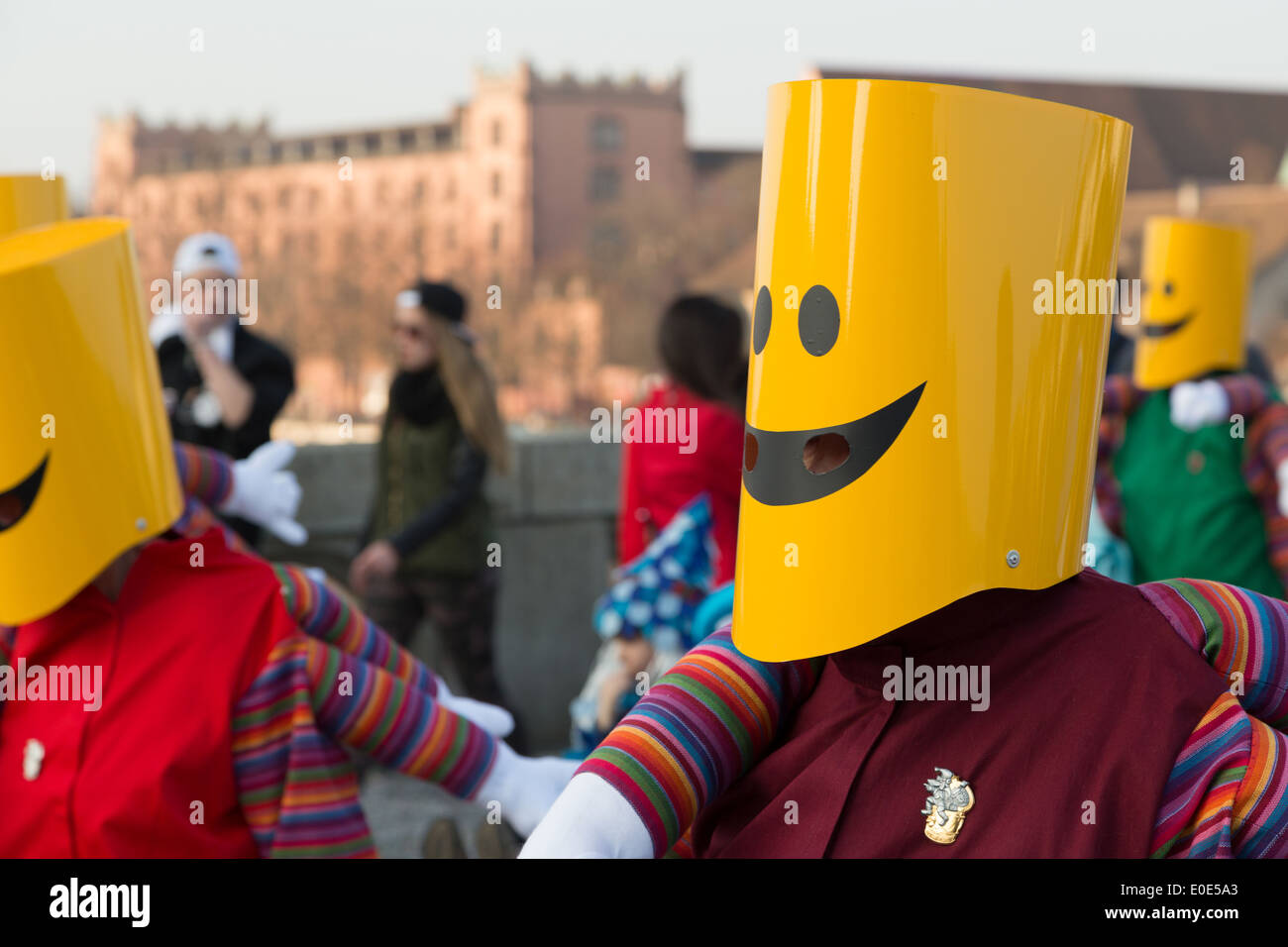 A photograph of people wearing yellow smiley face costumes at Basler ...