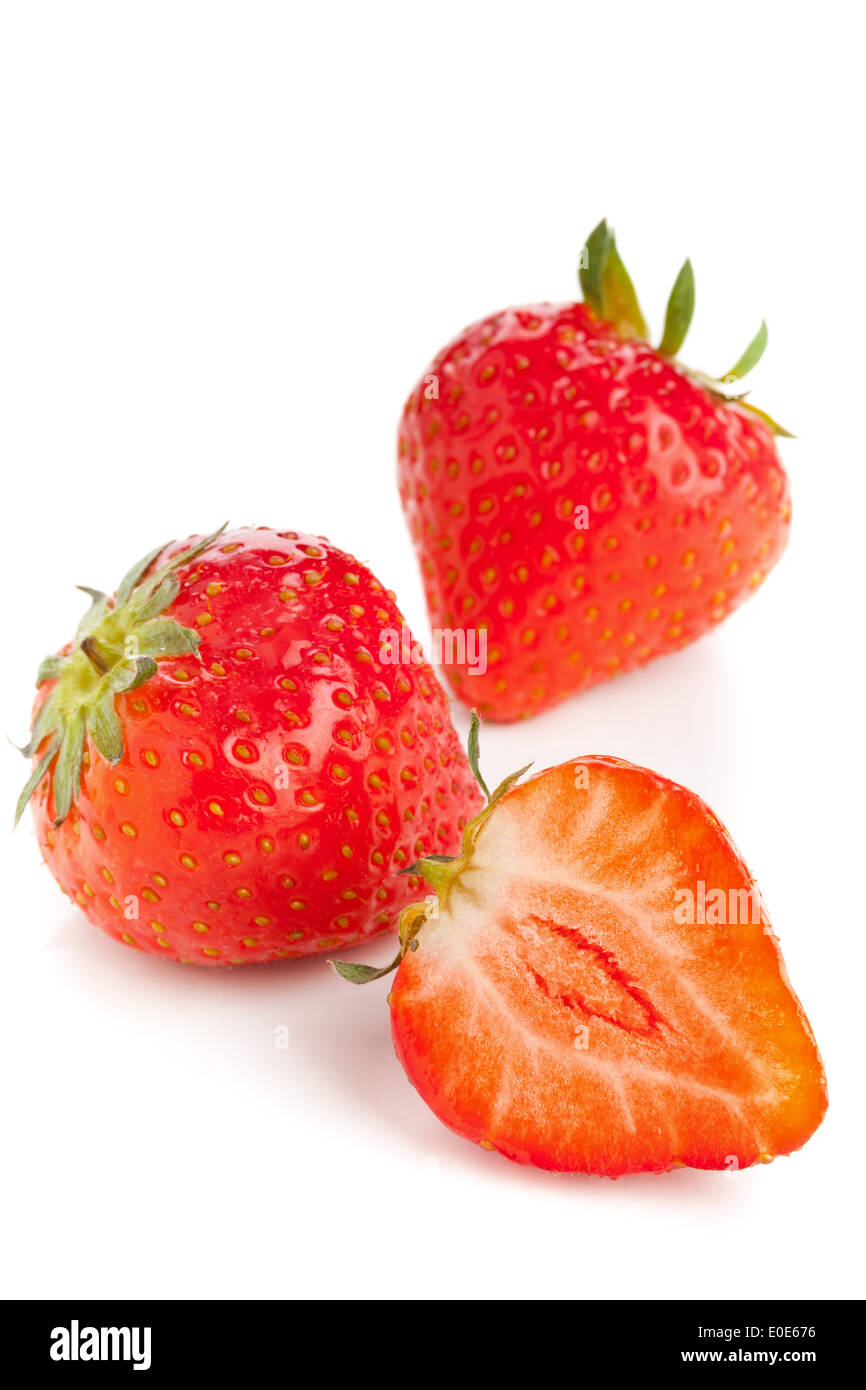 Organic ripe strawberries cut and whole over white background Stock ...