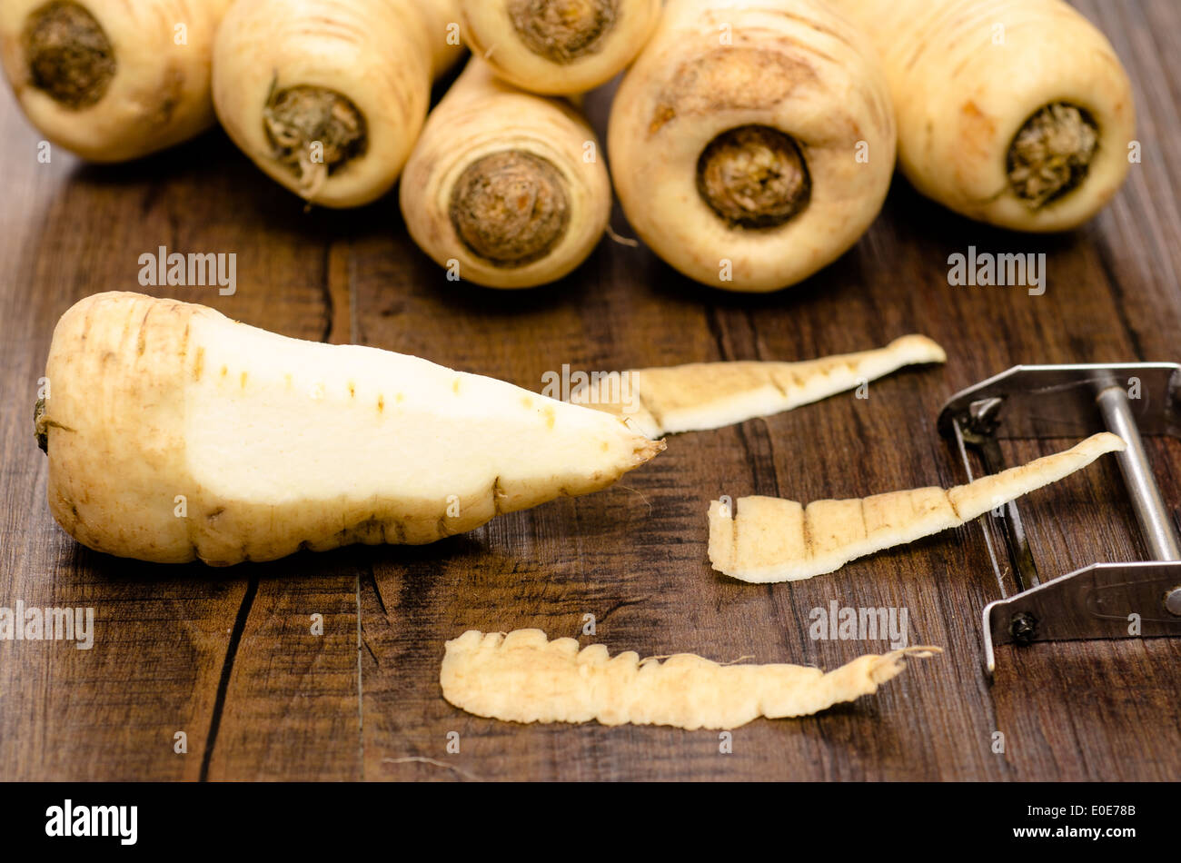 Root vegetable parsnip with potato peeler and peels Stock Photo - Alamy
