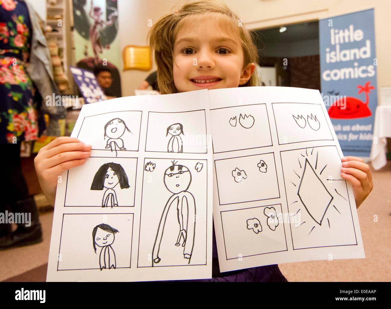 Toronto, Canada. 10th May, 2014. A girl shows the comics drew by ...