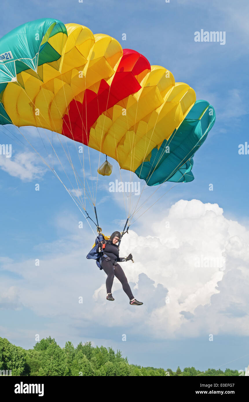 One day with parachutist in airfield. The girl skydiver landing under ...