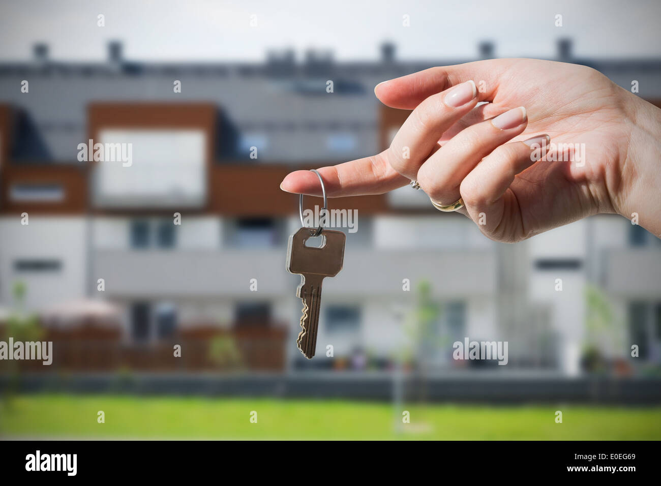 Woman's hand holding keys to new house Stock Photo - Alamy