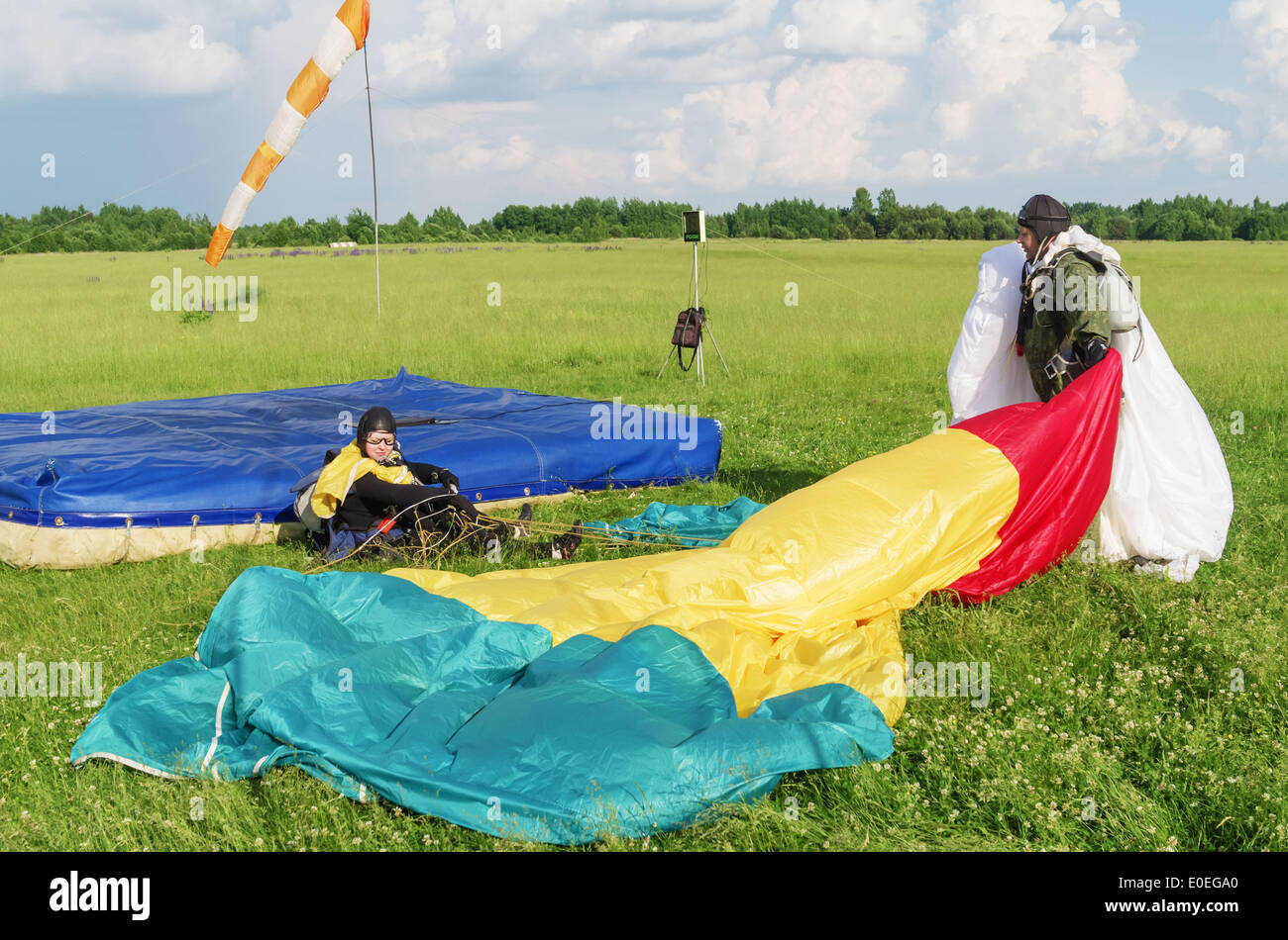 One day with parachutist in airfield. The girl skydiver after landing ...