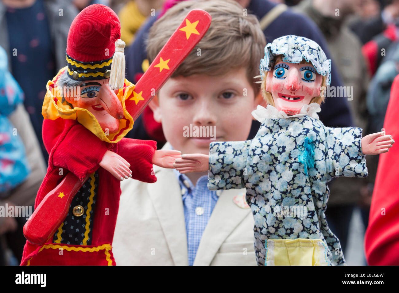 Covent Garden, London, UK. 11 May 2014. A young puppeteer holds up ...