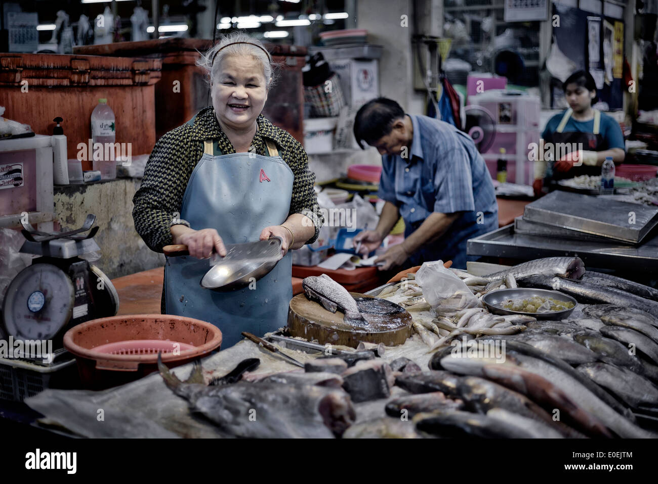 Thailand female fish vendor. Elderly woman working at Hua Hin indoor ...