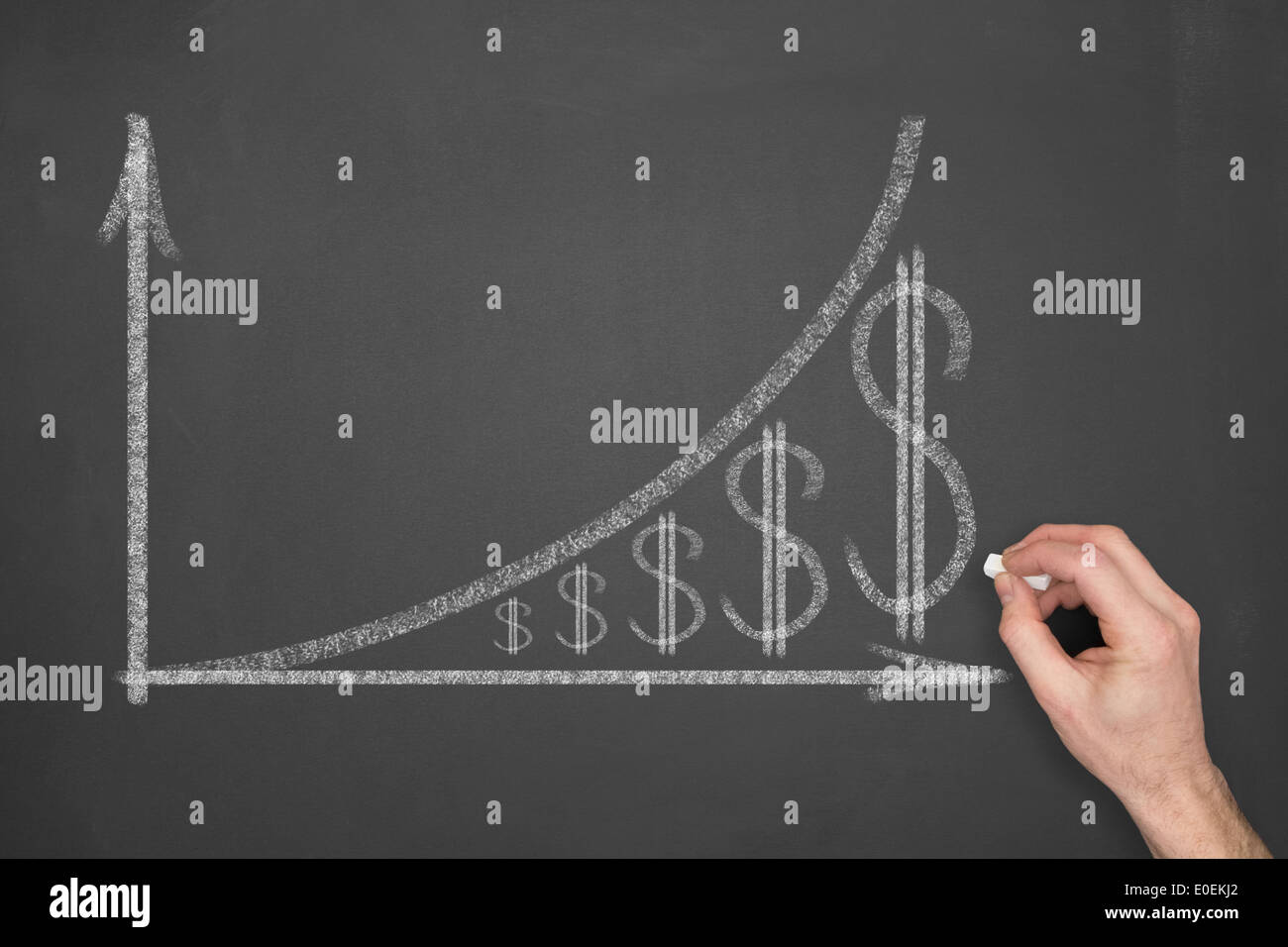 A hand drawing a business graph depicting an increase in profits on a ...
