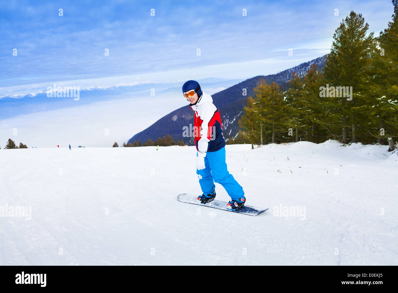 Man wearing ski mask standing on snowboard Stock Photo - Alamy