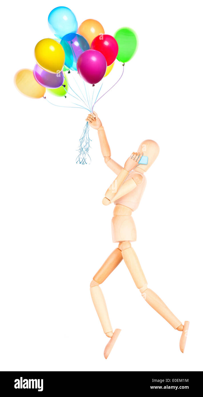 wooden Dummy with balloons talking on mobile phone Isolated on a white ...