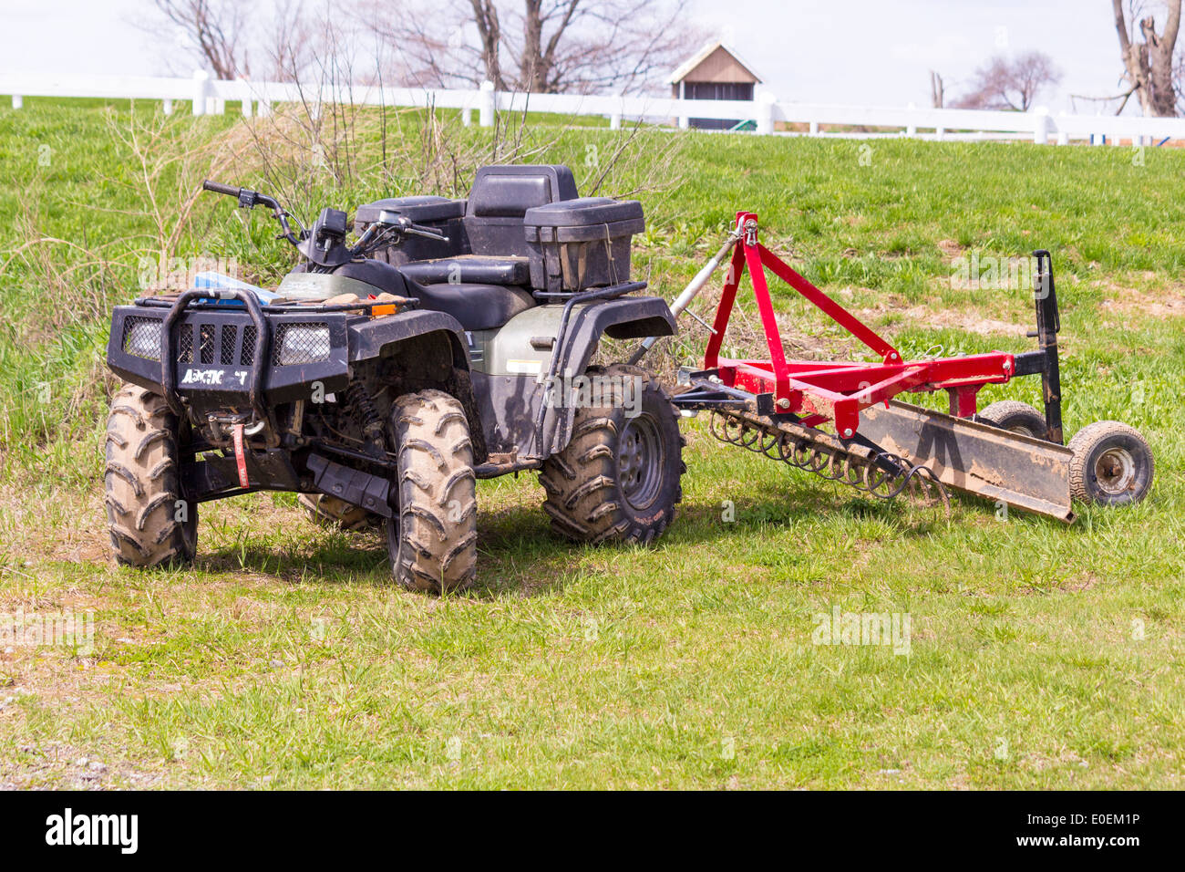 Arctic Cat four wheeler with rake grader attachment attached to 3 point ...