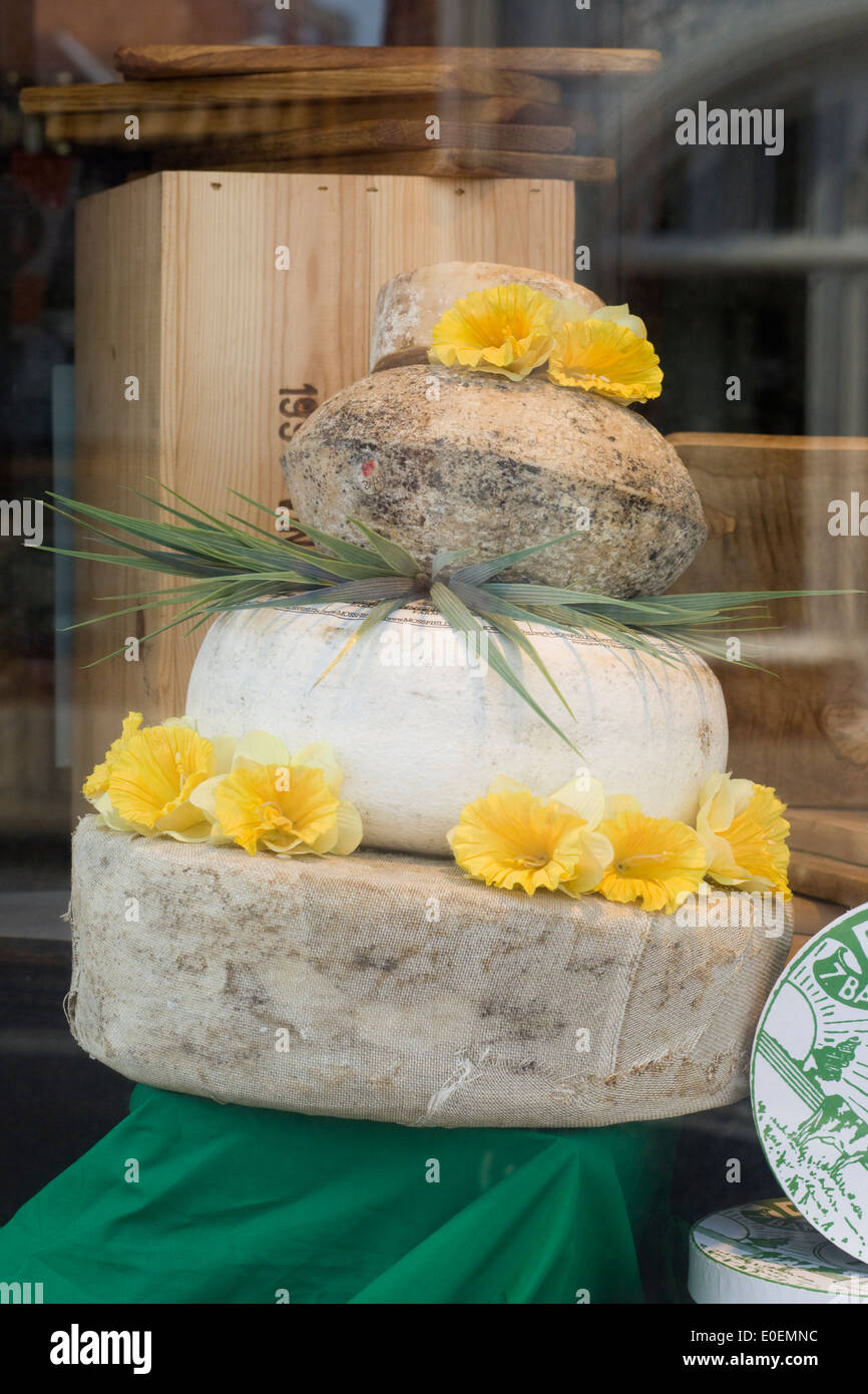 Various Cheeses on display in a shop window Stock Photo - Alamy
