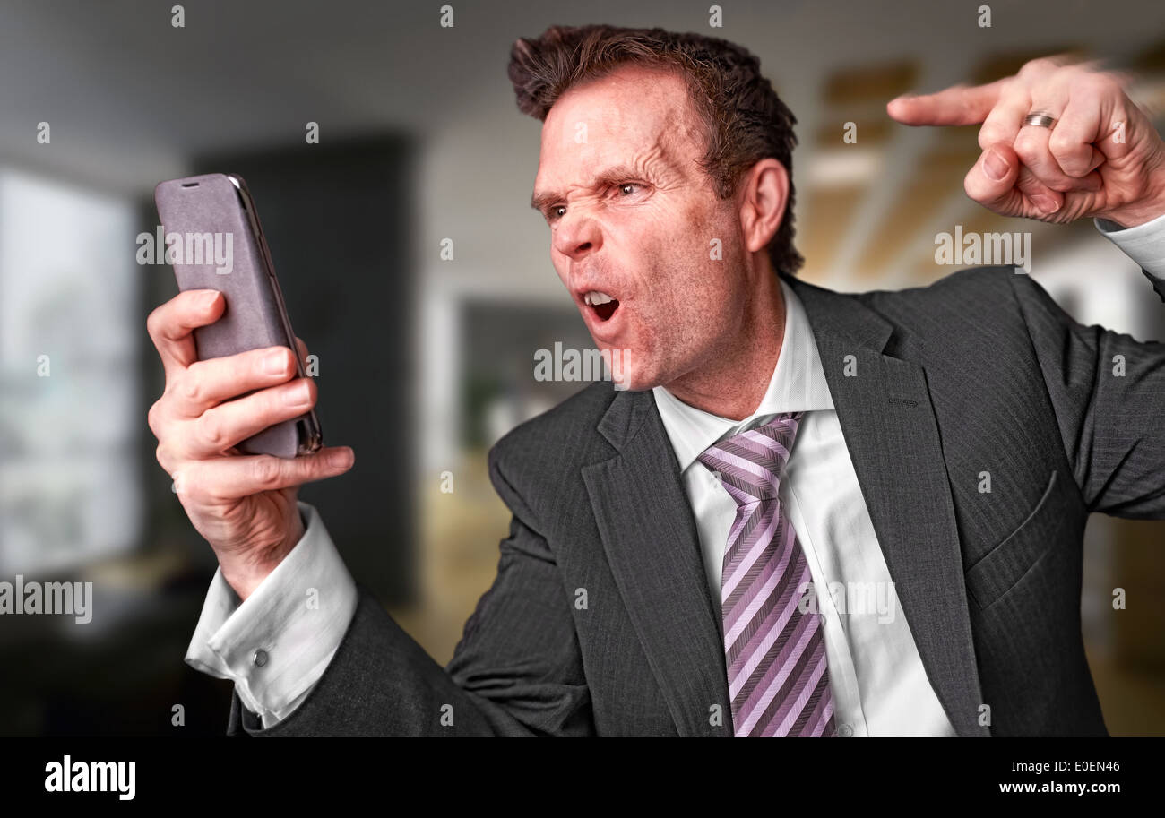 An angry businessman shouting down the phone Stock Photo - Alamy