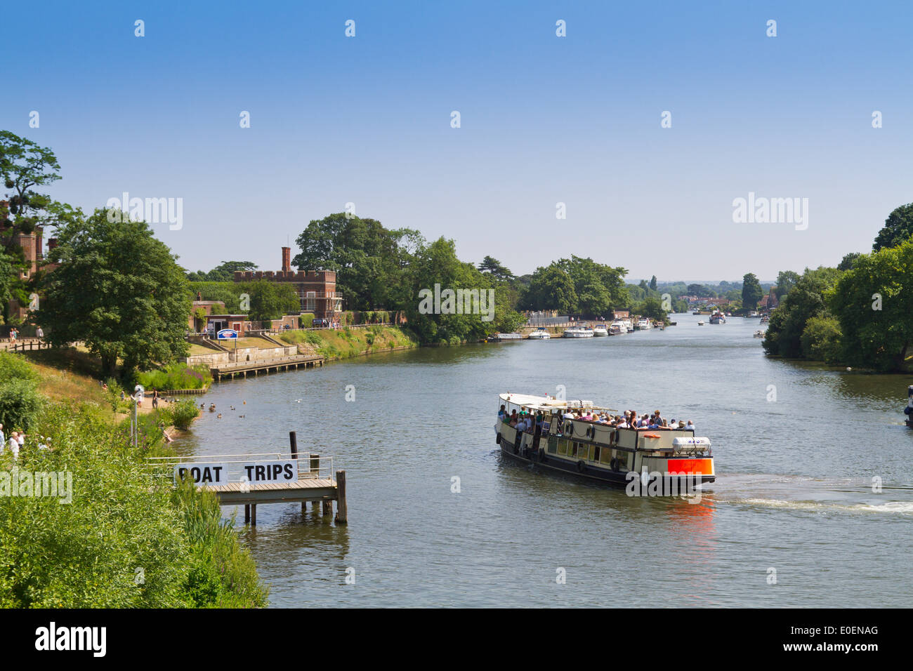 Boat passes Hampton Court on the River Thames in London England Stock ...